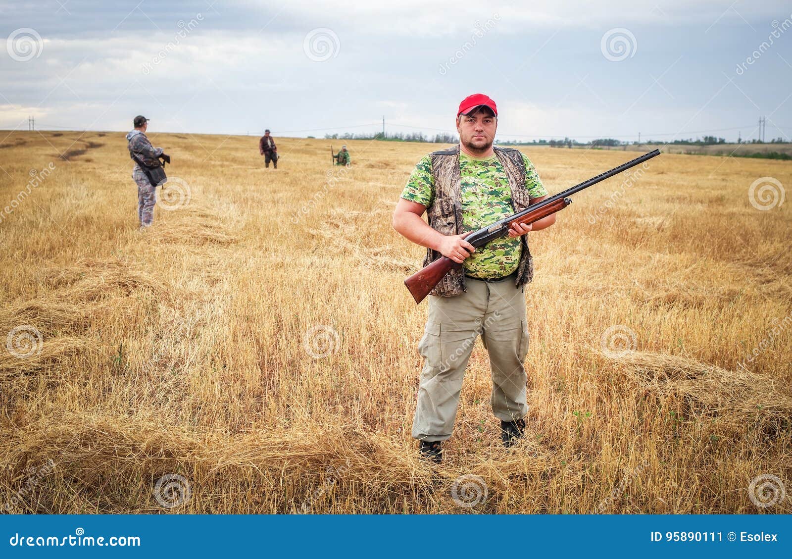 Group Of Men Hunters Going Through Tall Grass On Rural Field At Sunset ...