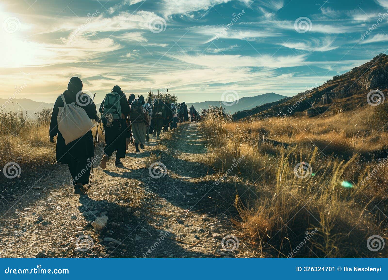 A Group of Individuals Walking in a Line Down a Dusty Path, Surrounded ...