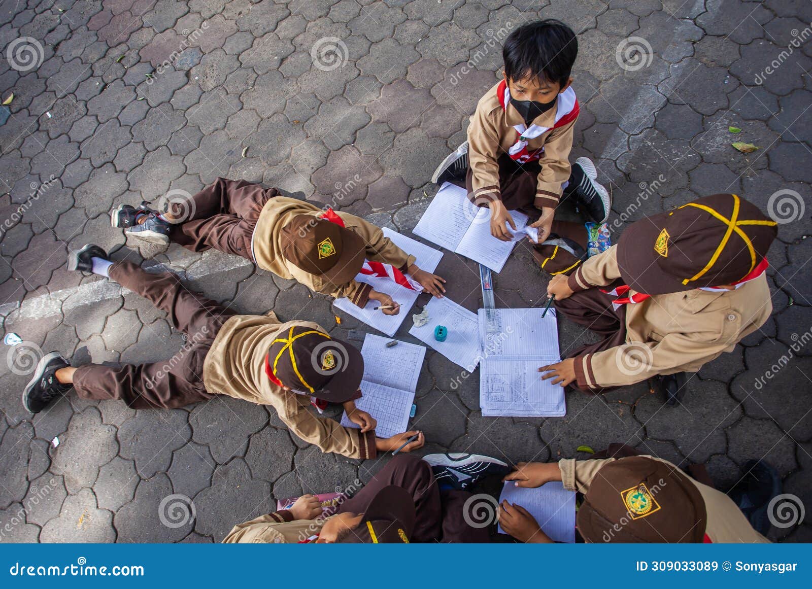 A Group of Indonesian Scouts are Working on Assignments Together ...