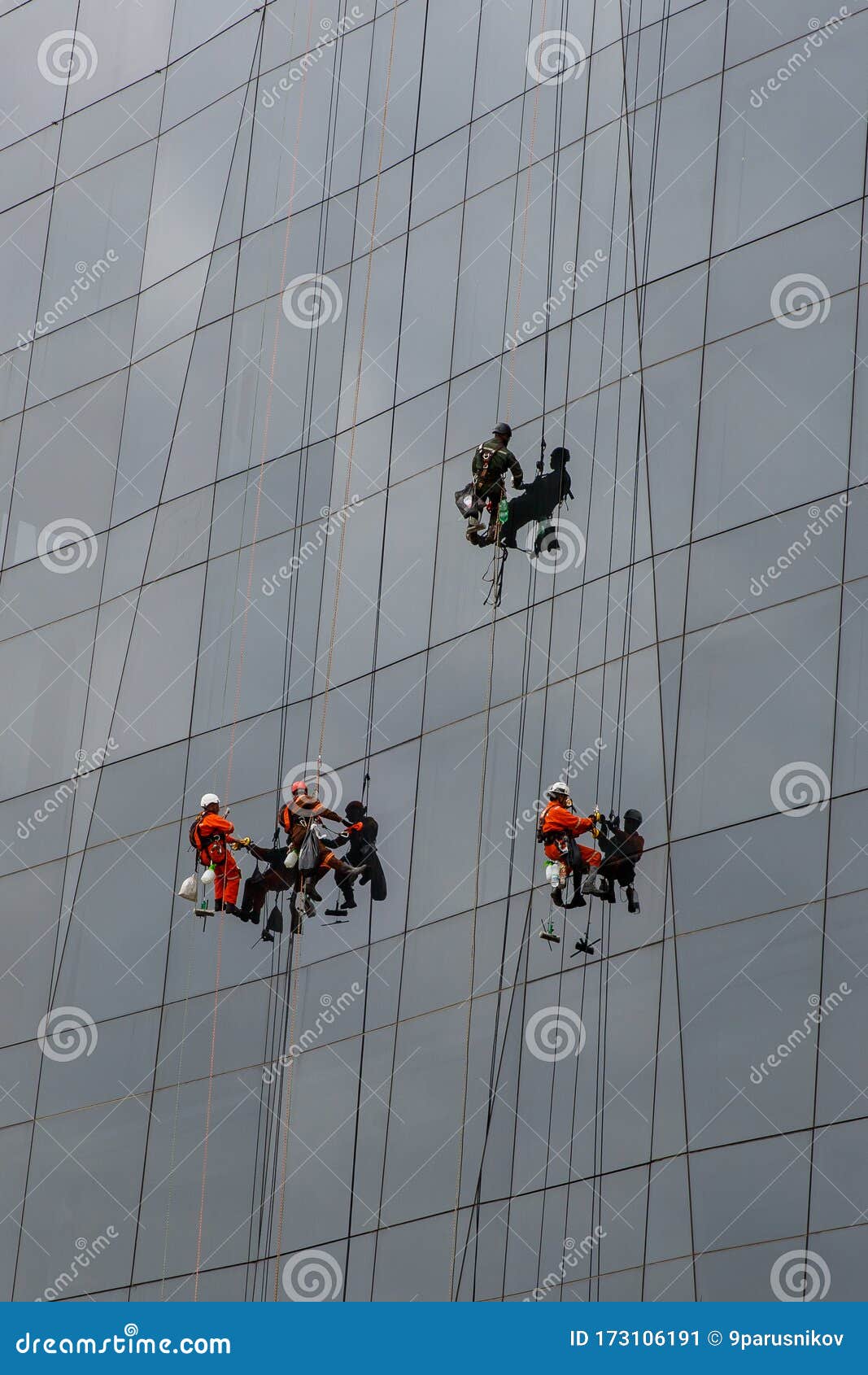 Group of Industrial Climbers Cleaning Windows Service on High Rise ...