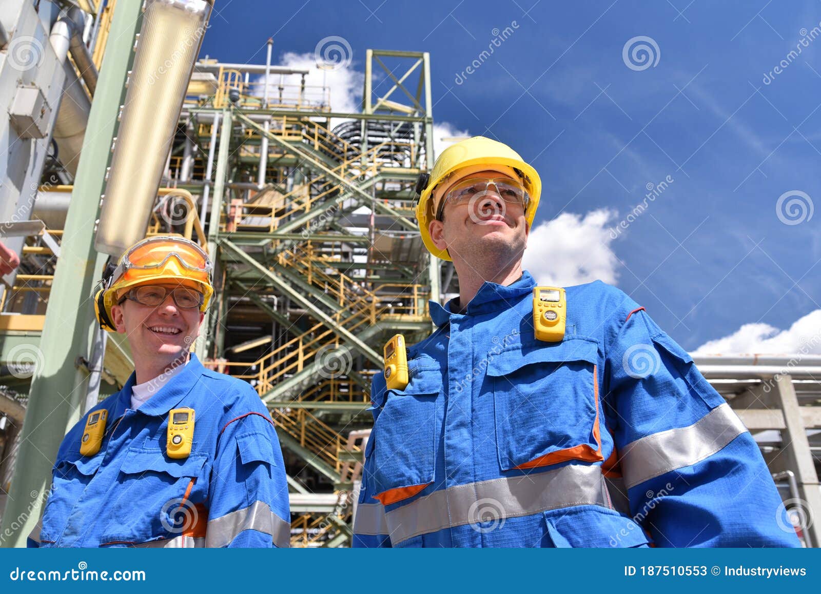 Group of Industrial Workers in a Refinery - Oil Processing Equipment ...