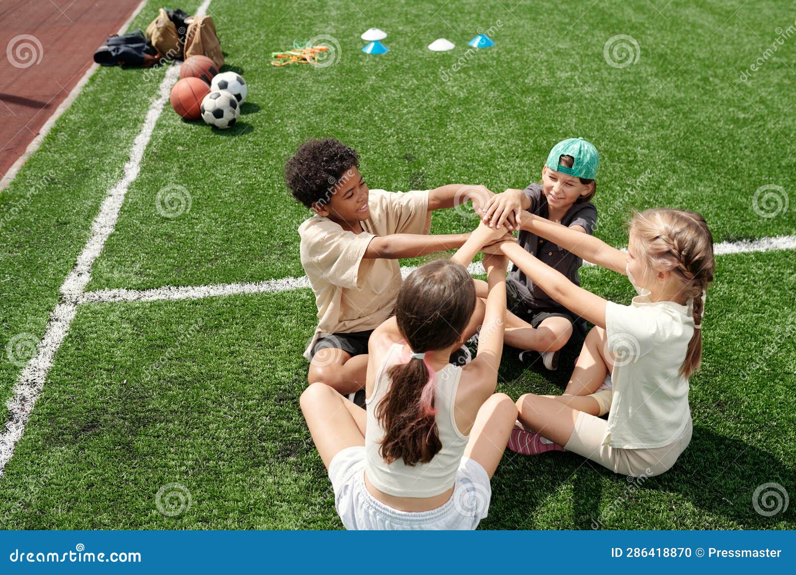 Group of Intercultural Children Lifting Stretched Arms and Making Pile ... Group of Intercultural Children Lifting Stretched Arms and Making Pile ...