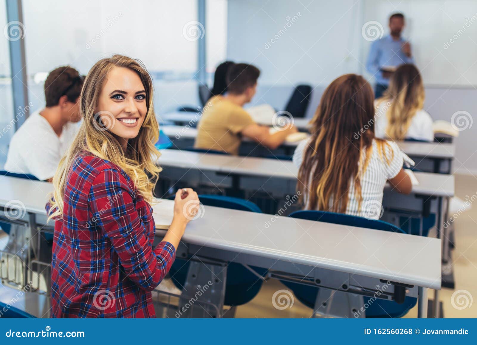 International Students Writing in Lecture Hall and Talking Stock Photo ...