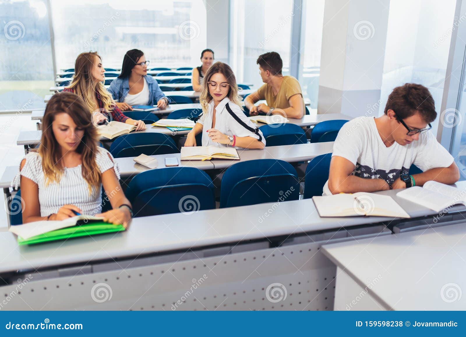 International Students Writing in Lecture Hall and Talking Stock Photo ...