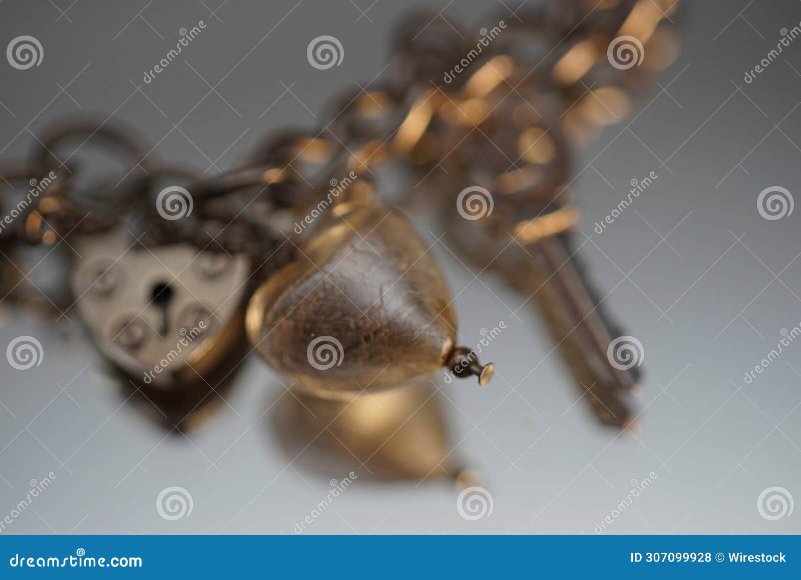 A Group of Keys and a Chain on a Table in Front of a Clock Stock Photo ...
