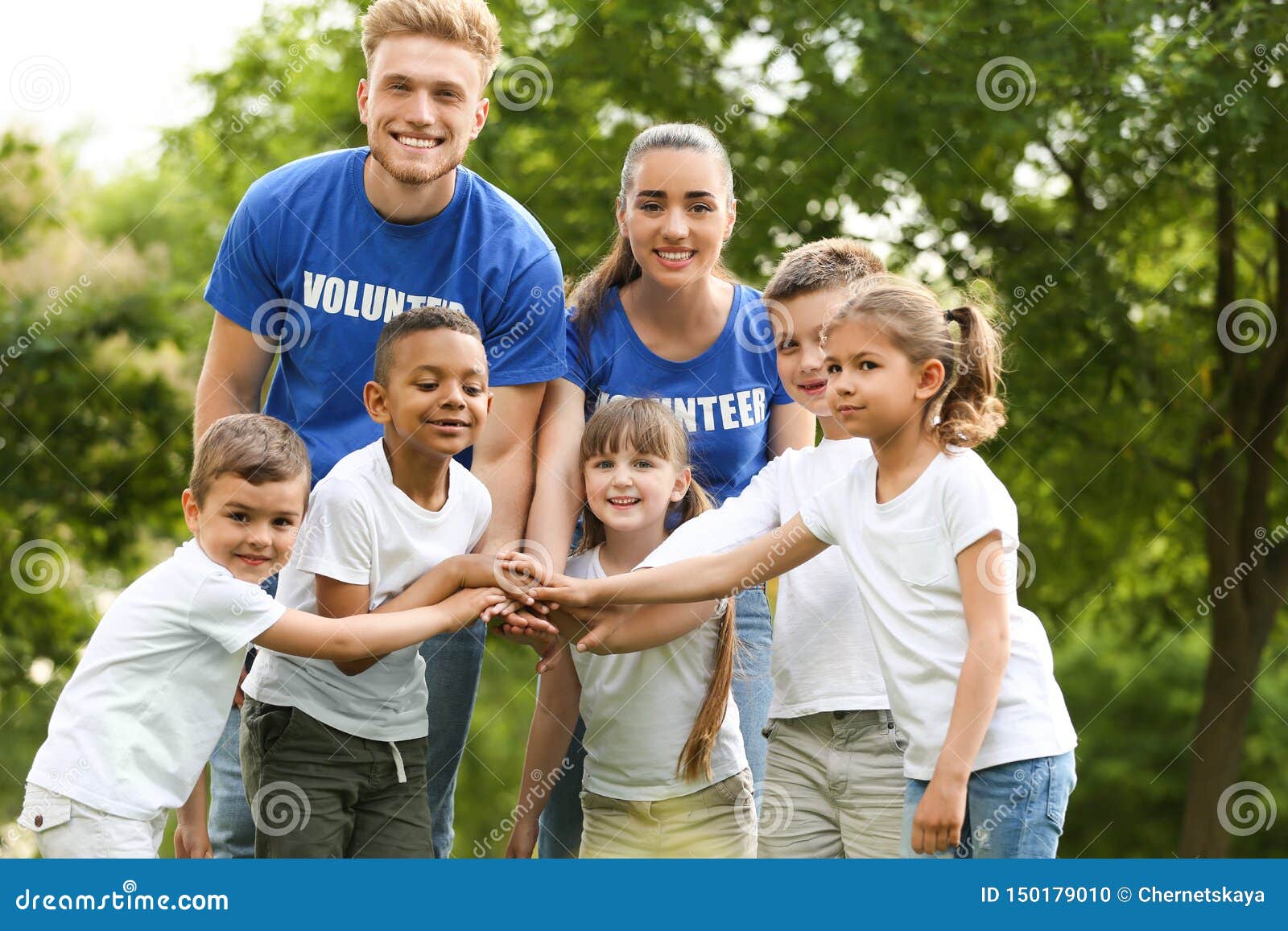 Group of Kids Joining Hands with Volunteers Stock Photo - Image of ...