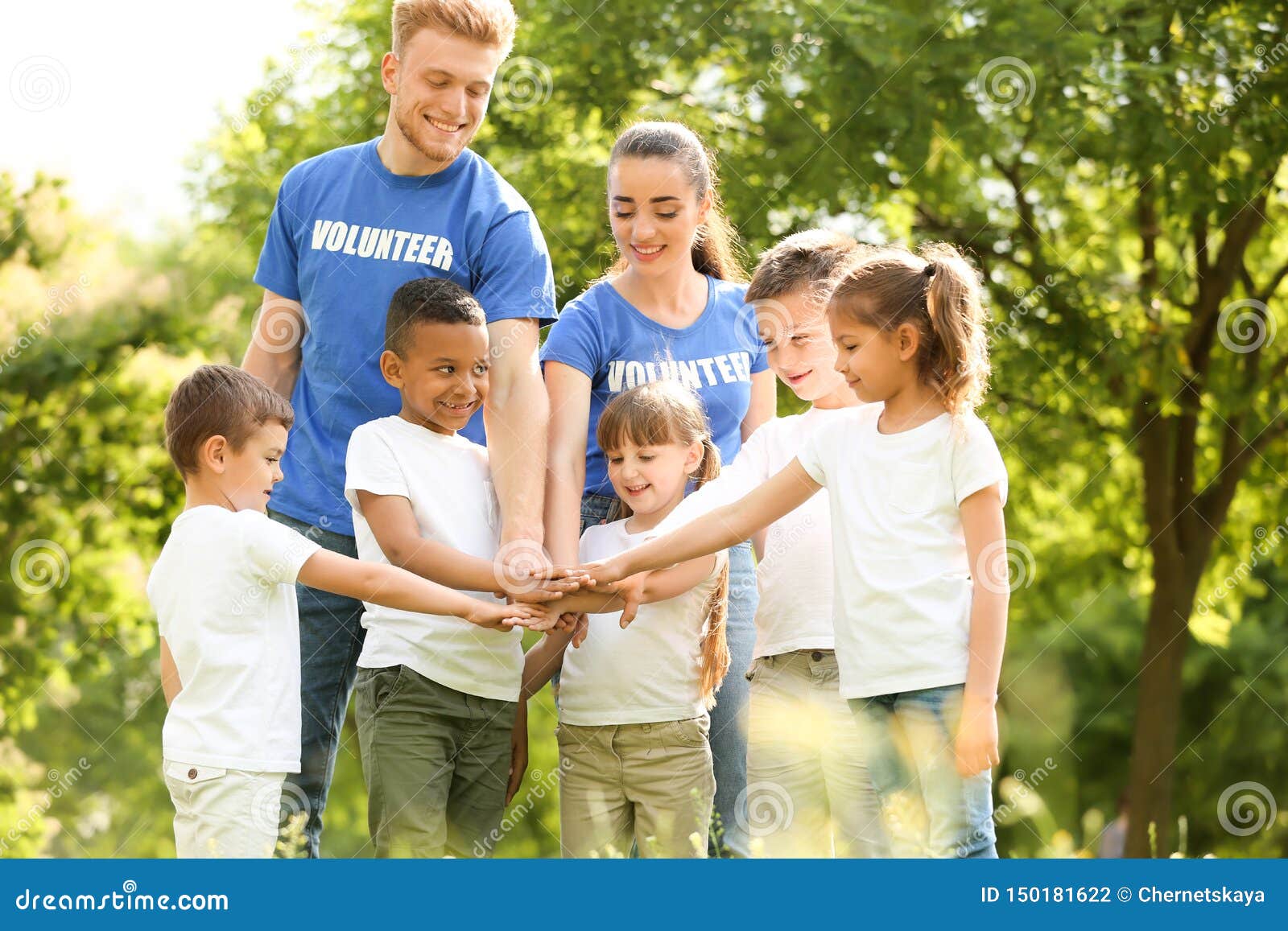 Group of Kids Joining Hands with Volunteers Stock Photo - Image of ...