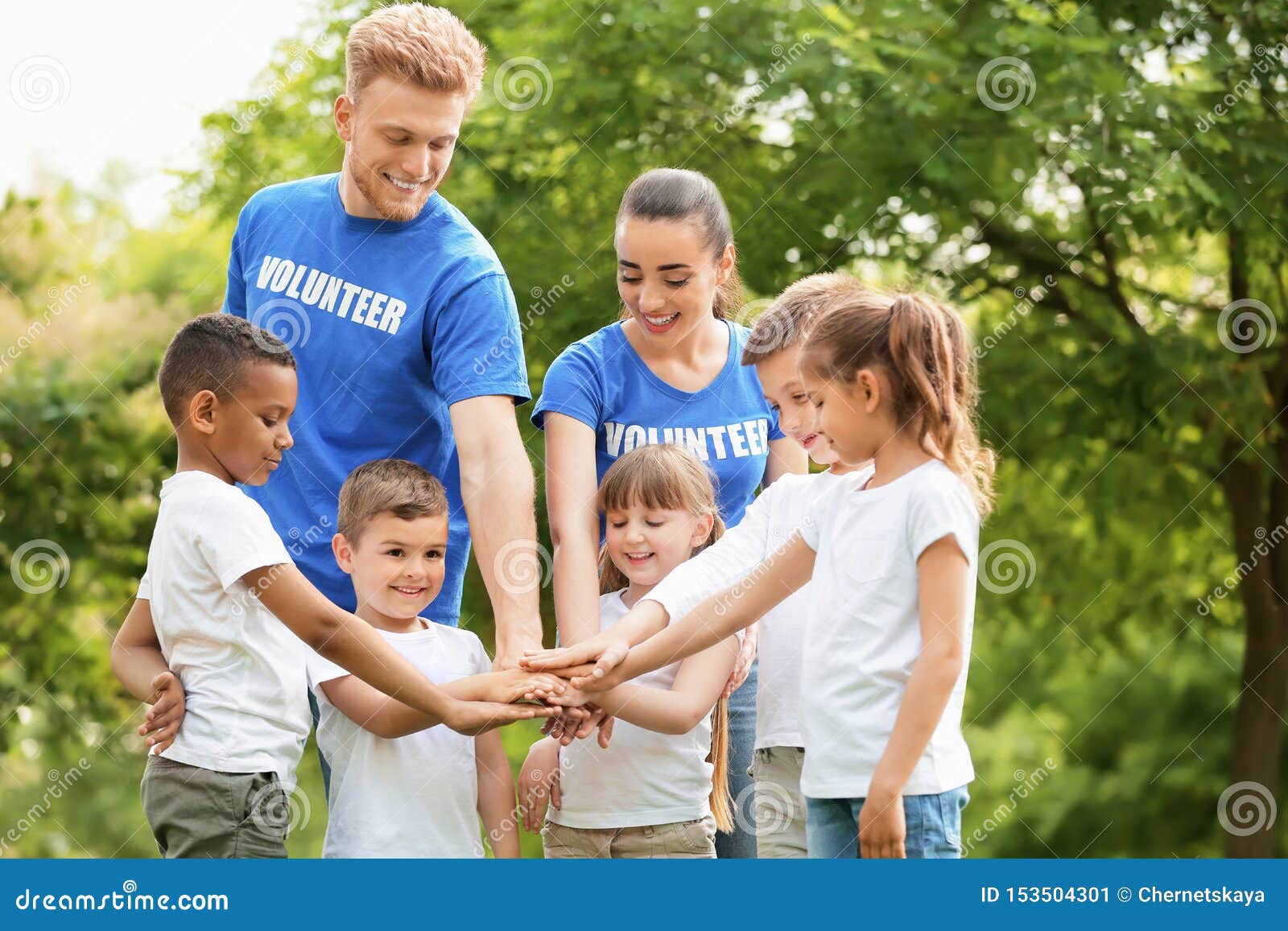 Group Of Kids Joining Hands With Volunteers Stock Image | CartoonDealer ...
