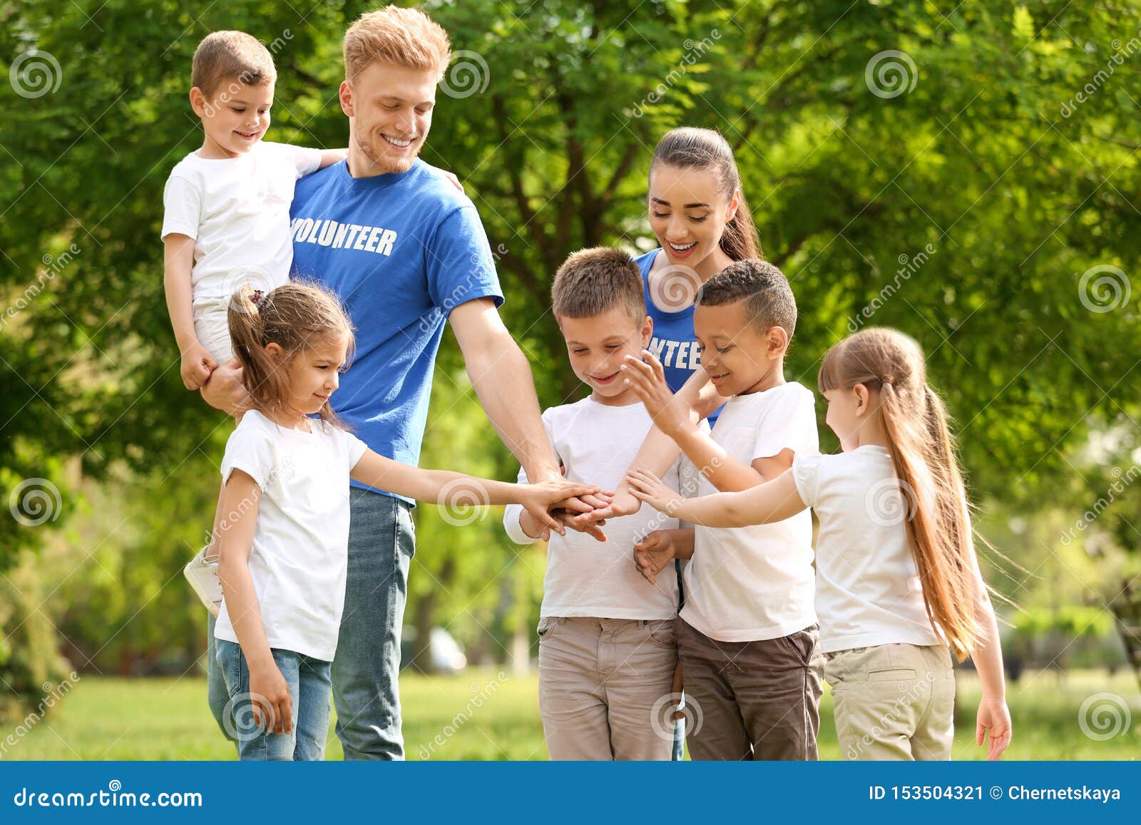 Group of Kids Joining Hands with Volunteers Stock Image - Image of kids ...