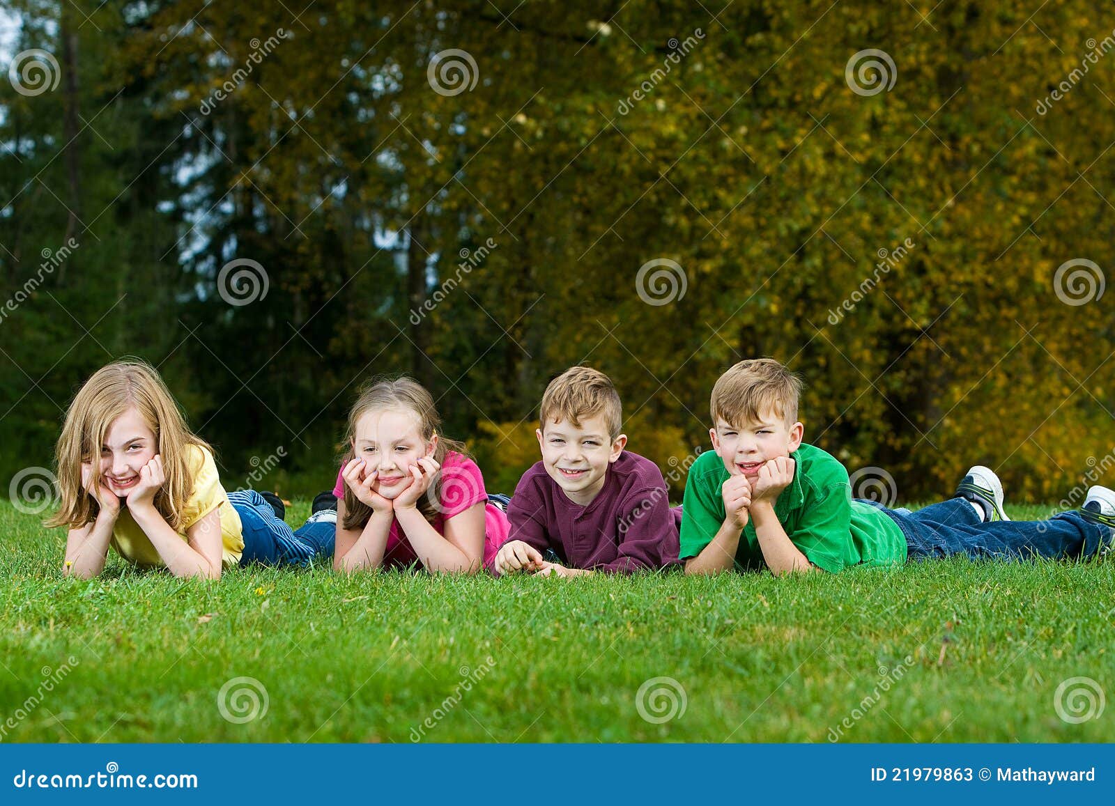 A Group of Kids Laying Down in the Grass Stock Image - Image of laying ...