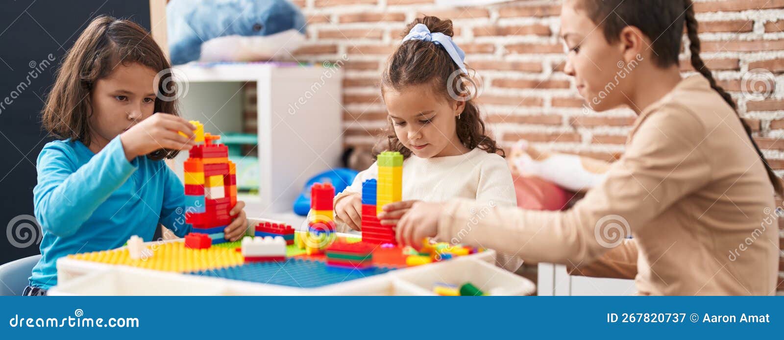 Group of Kids Playing with Construction Blocks Sitting on Table at ...