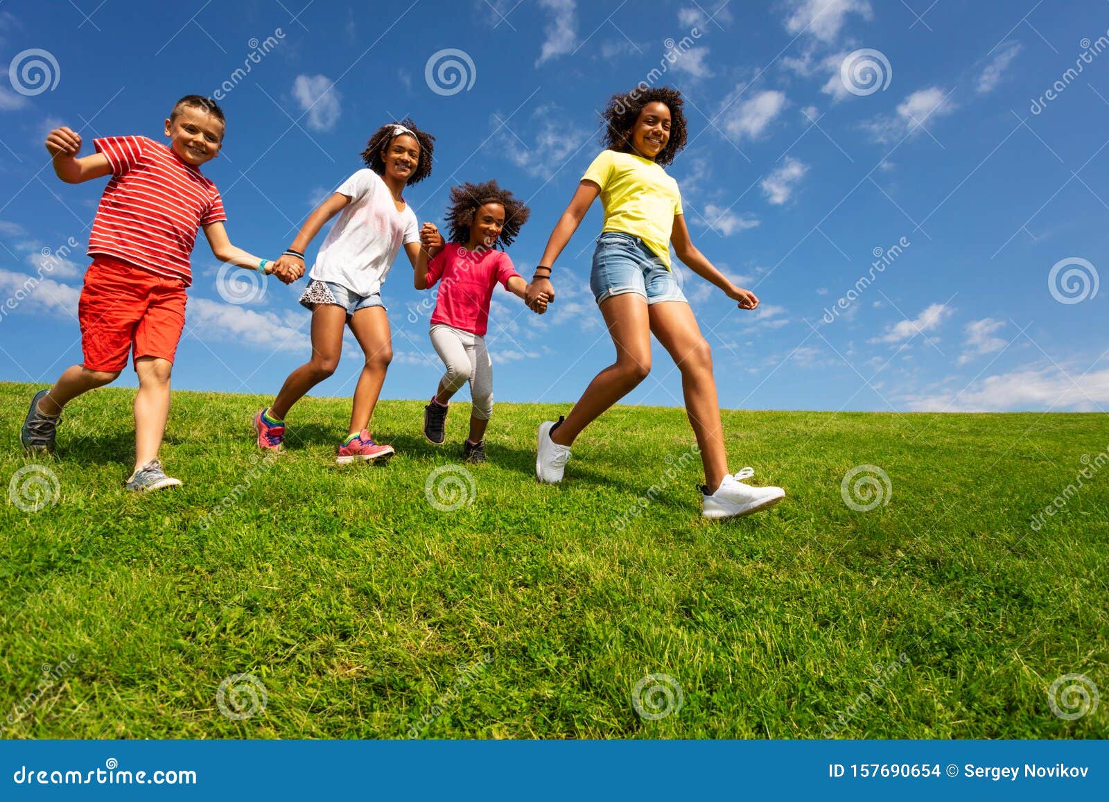Group of Kids Run Downhill Holding Hands and Smile Stock Photo - Image ...