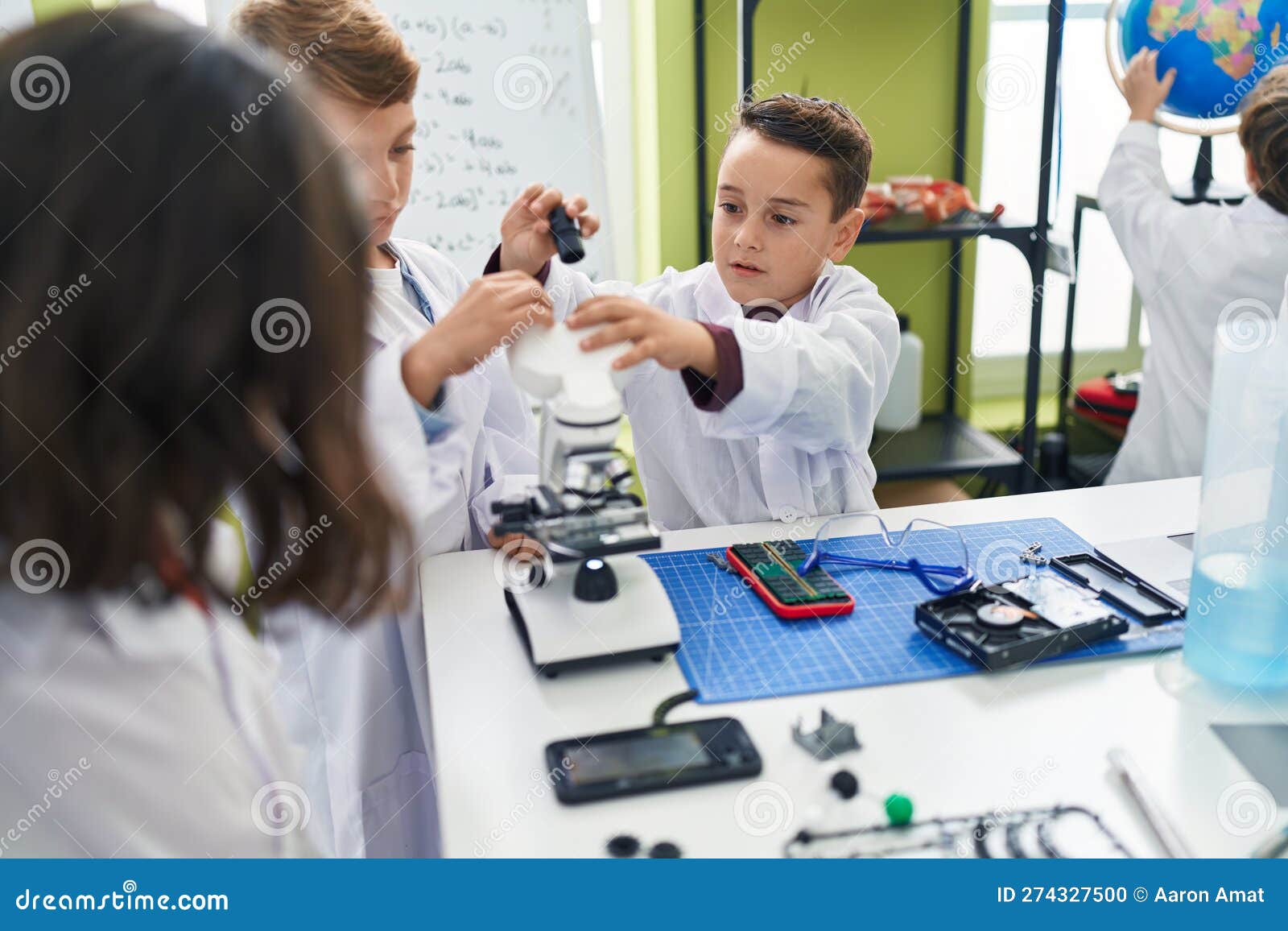 Group of Kids Students Using Microscope Repairing Smartphone at ...