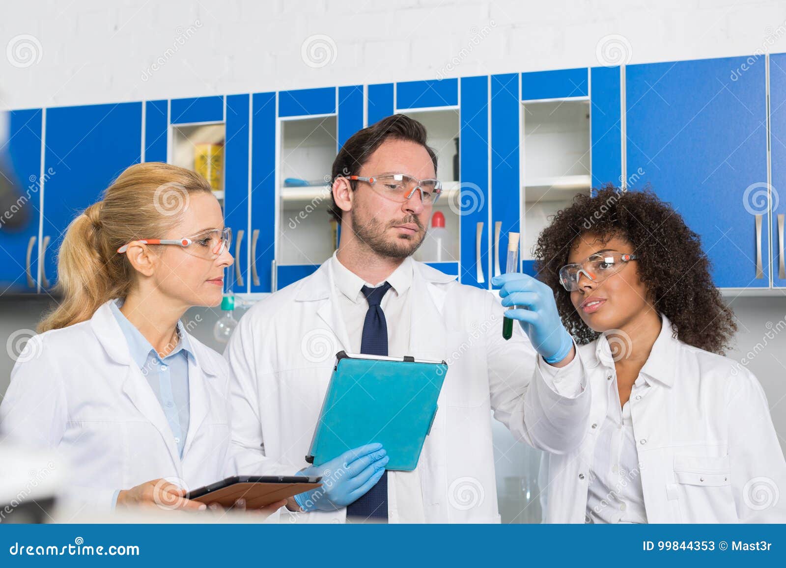 Group of Laboratory Scientists Examining Green Liquid in Test Tube ...