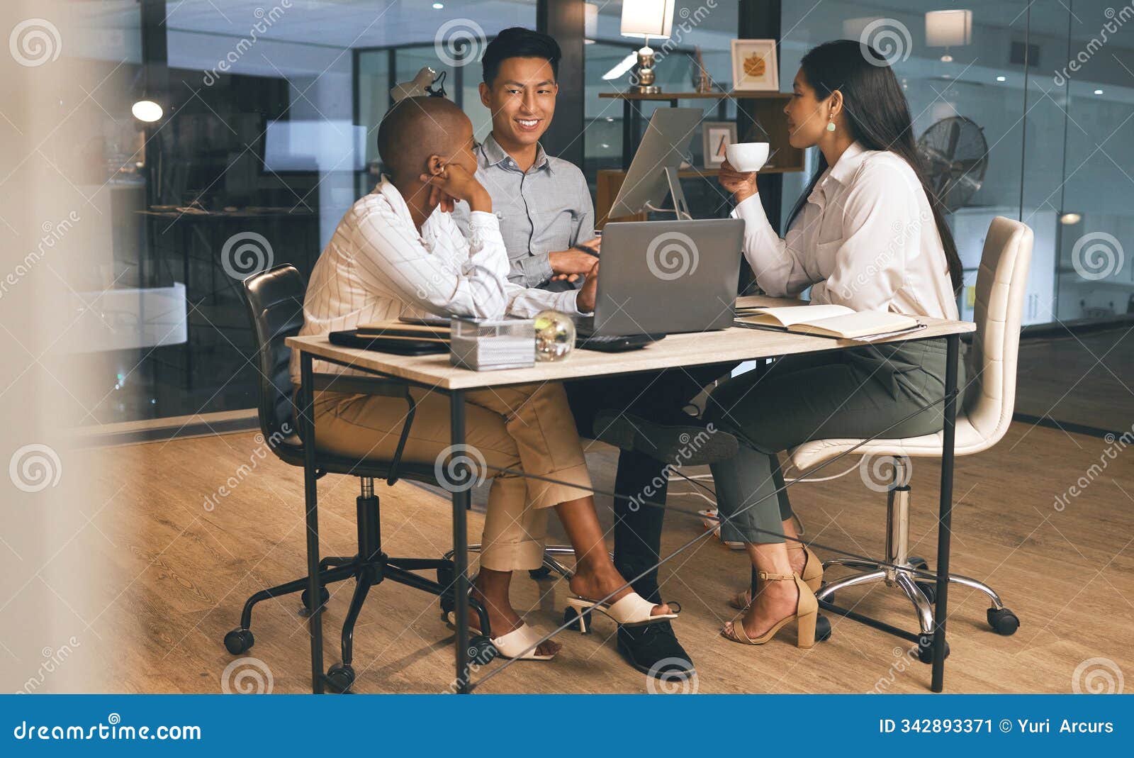 Group, Laptop and Business People in Discussion at Night, Planning or ...