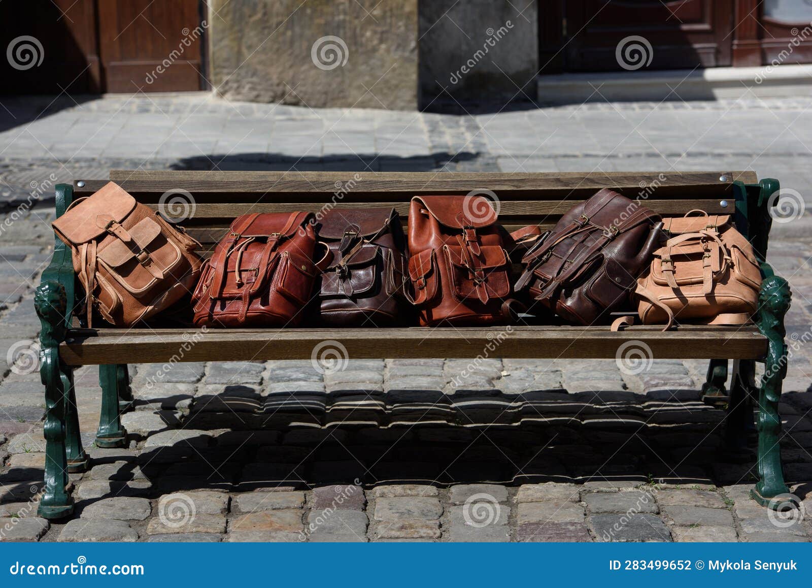 Group of Leather Backpacks on a Wooden Bench Stock Photo - Image of ...