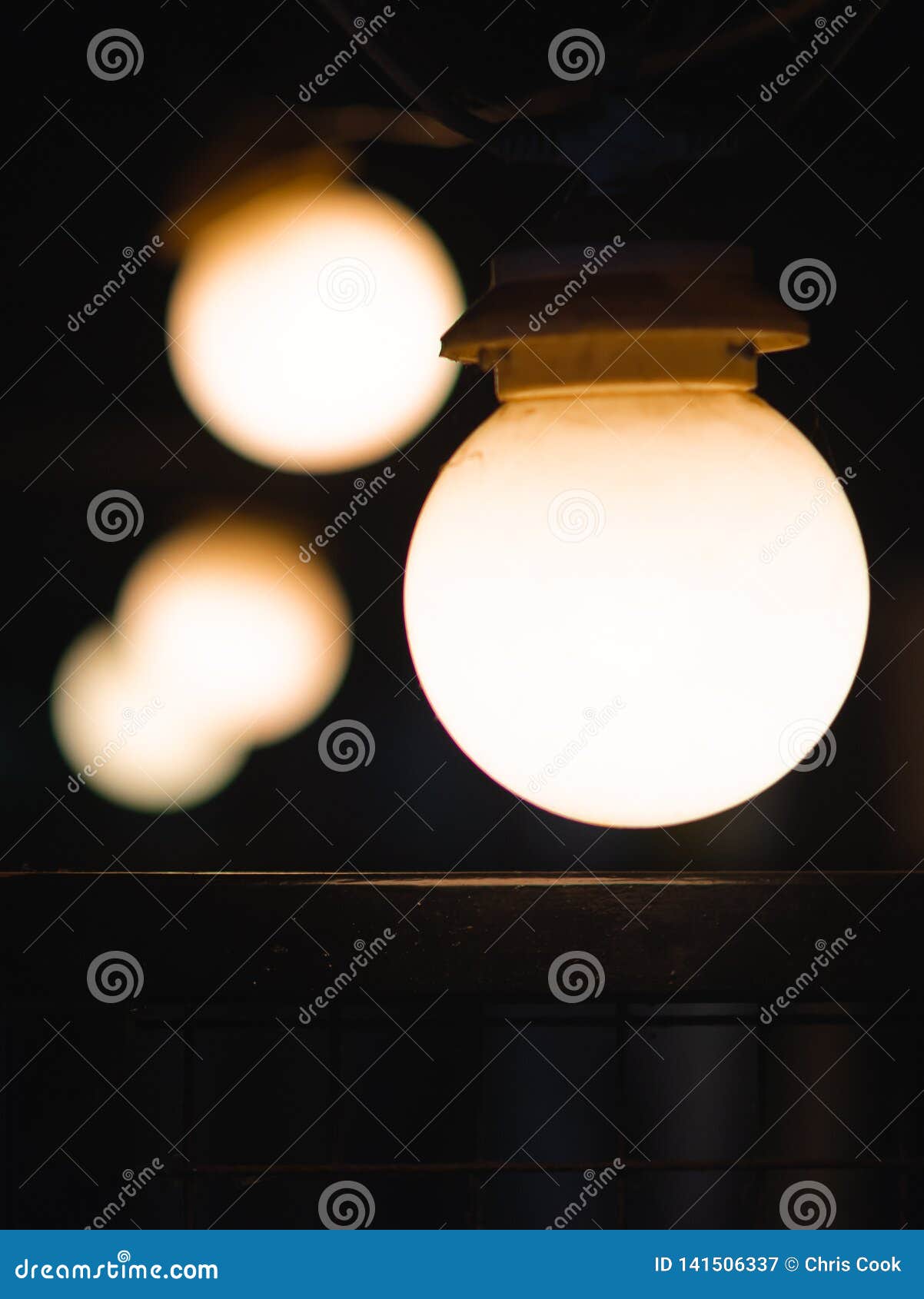 A Group of 4 Light Bulbs in a Line on a Dark Background Stock Image ...