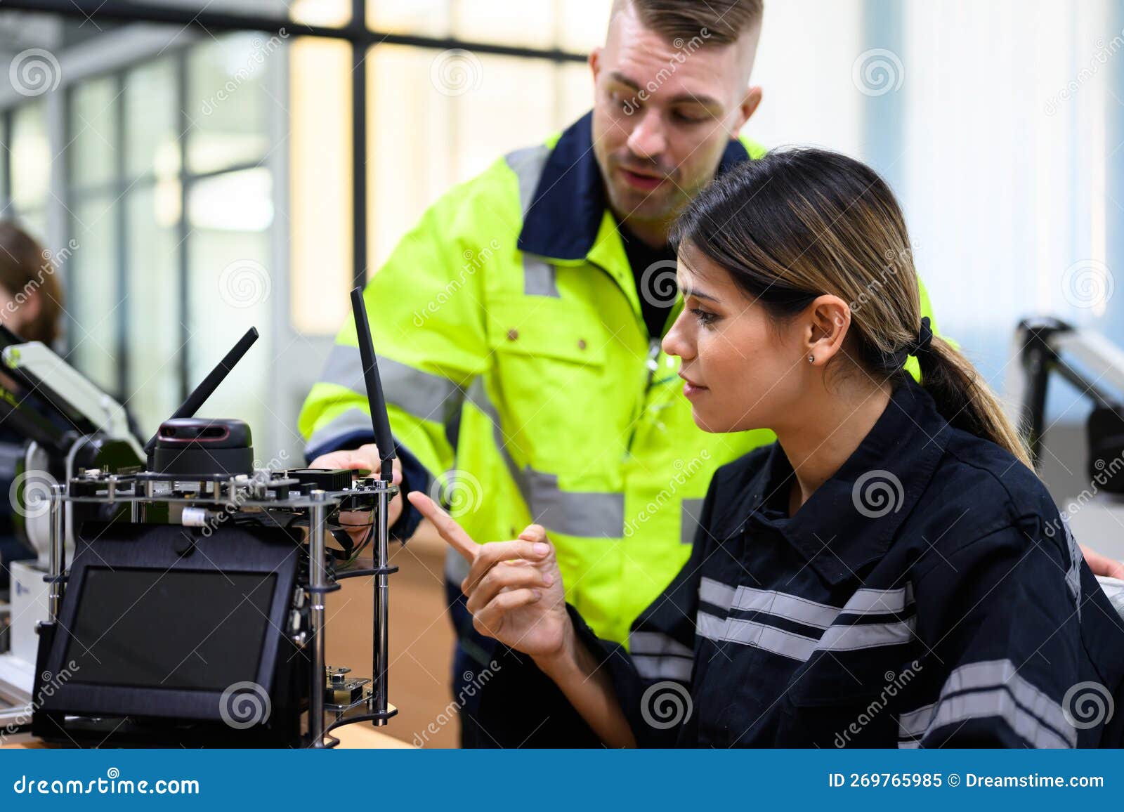 Group of Maintenance Engineers Checking and Repairing Automatic Robotic ...