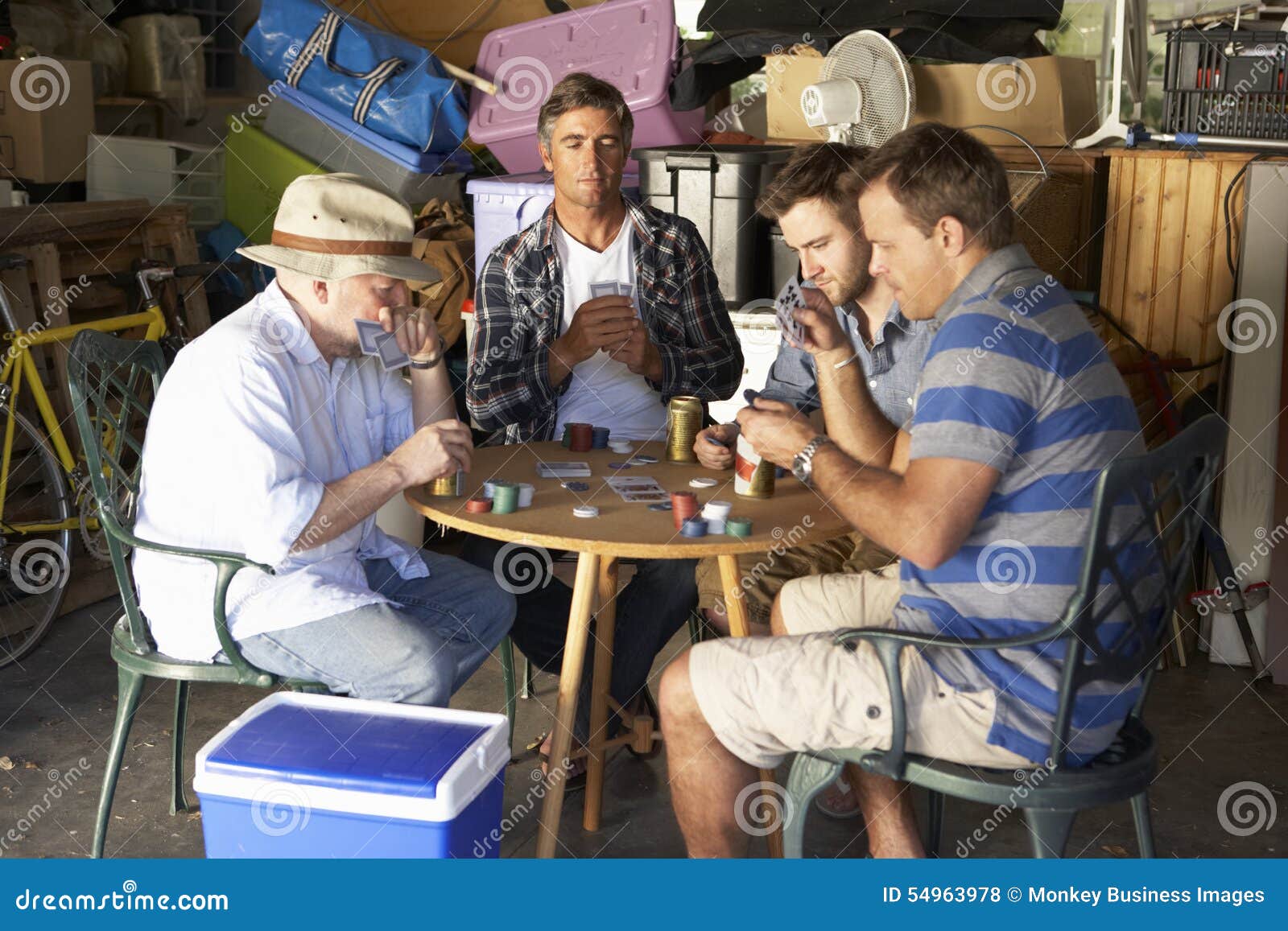 Group of Male Friends Playing Cards in Garage Stock Photo - Image of ...