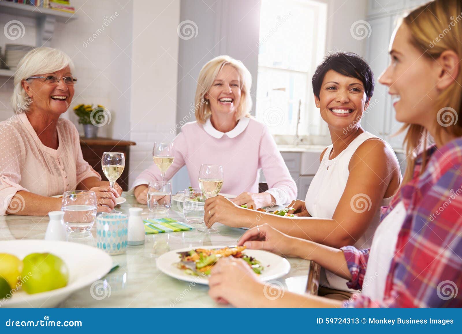 Group Of Mature Female Friends Enjoying Meal At Home Stock Image