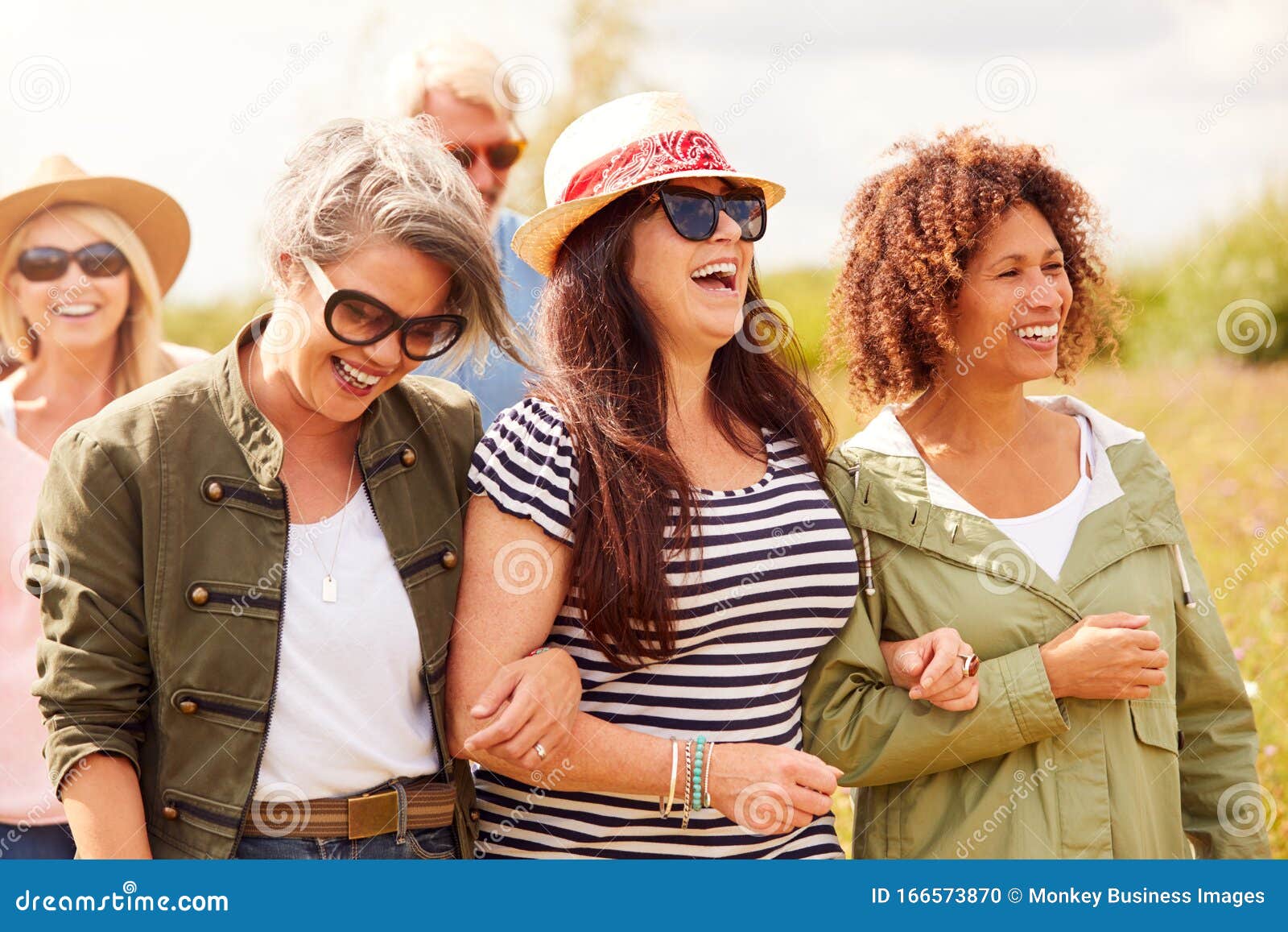 Group of Mature Friends Walking Along Path through Yurt Campsite Stock ...