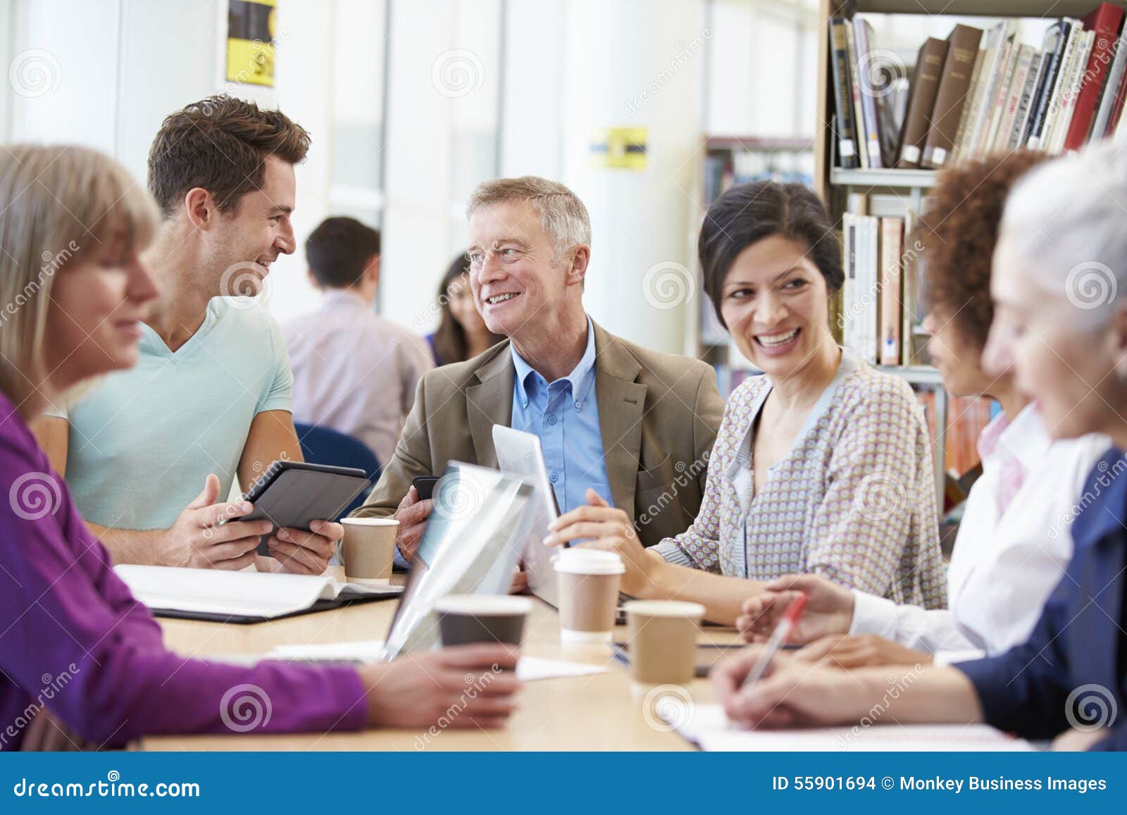 Group of Mature Students Collaborating on Project in Library Stock ...