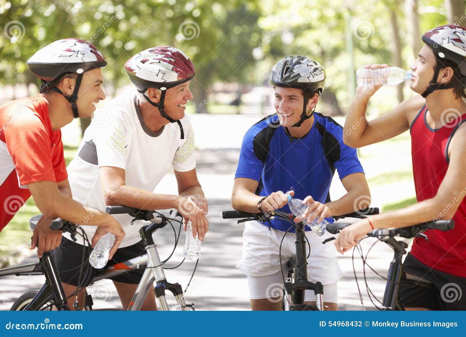 Group of Men Resting during Cycle Ride through Park Stock Photo - Image ...