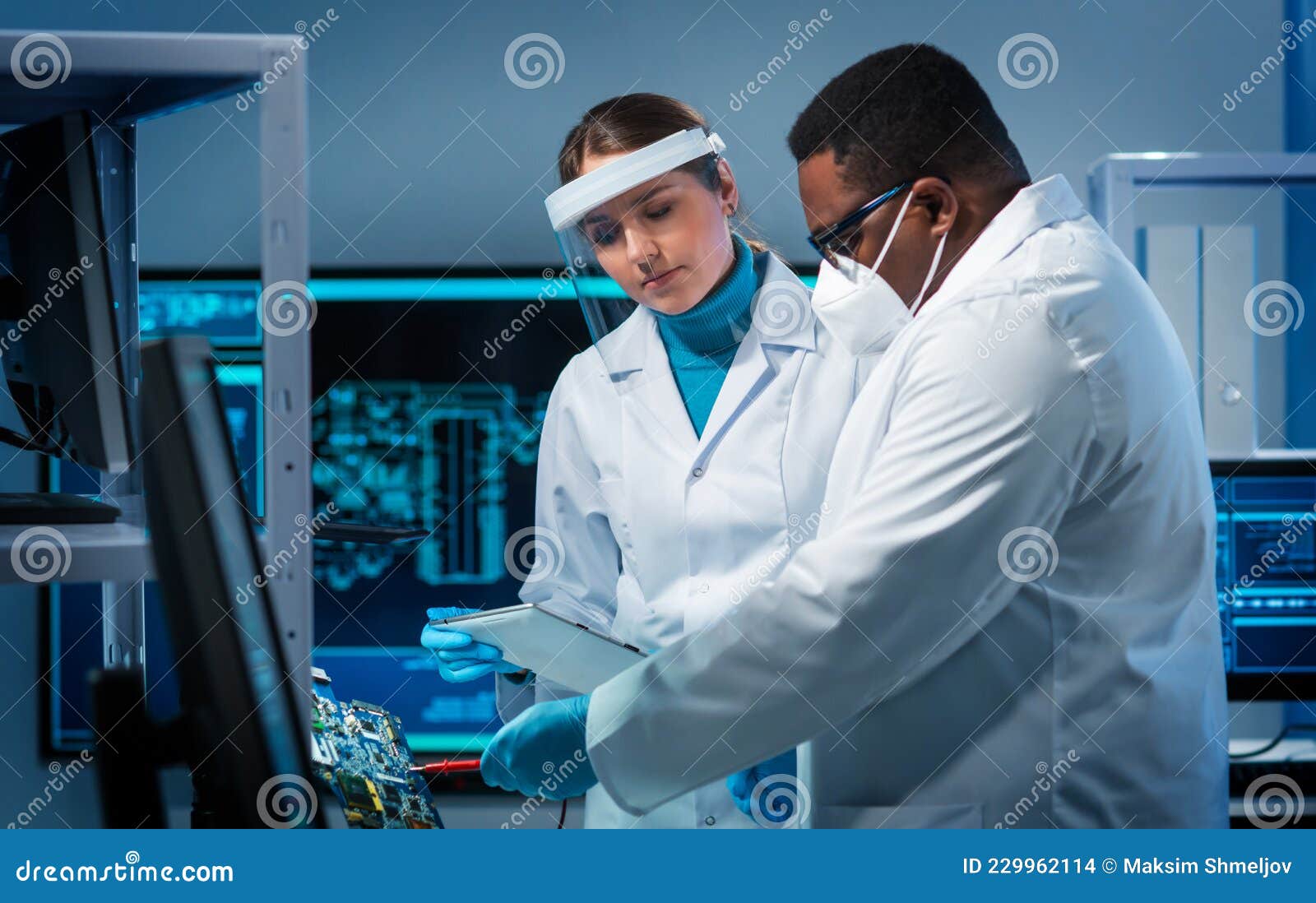 Group of Microelectronic Engineers Discussing in a Modern ...