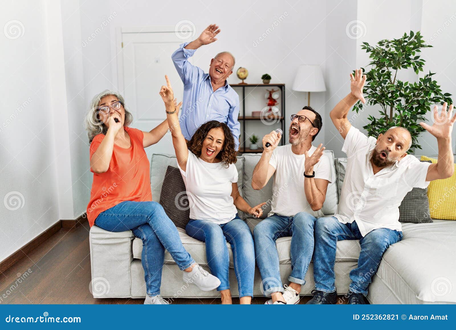 Group of Middle Age Friends Having Party Singing Song Using Microphone ...