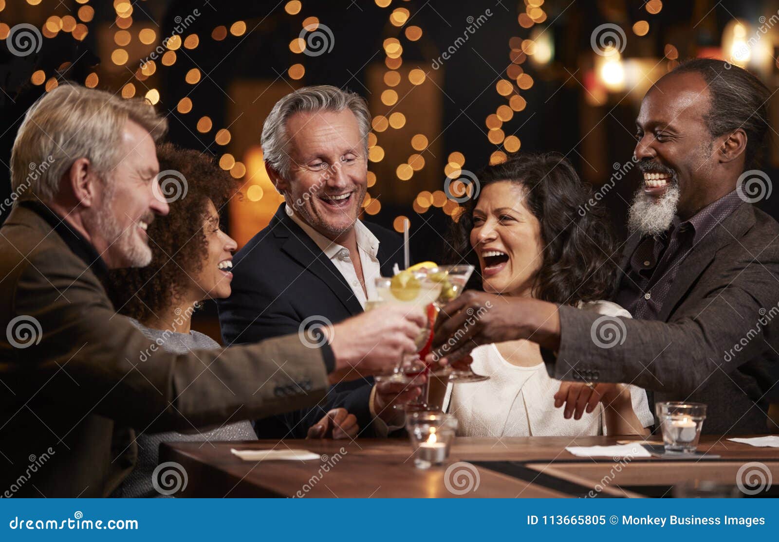 Group of Middle Aged Friends Celebrating in Bar Together Stock Image ...