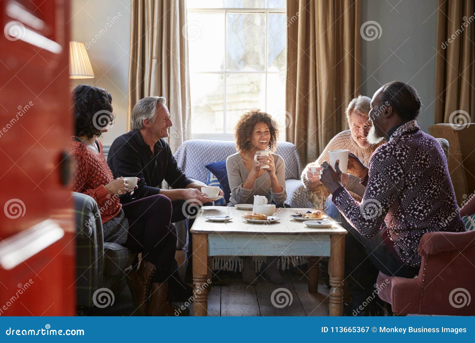 Group of Middle Aged Friends Meeting Around Table in Coffee Shop Stock ...