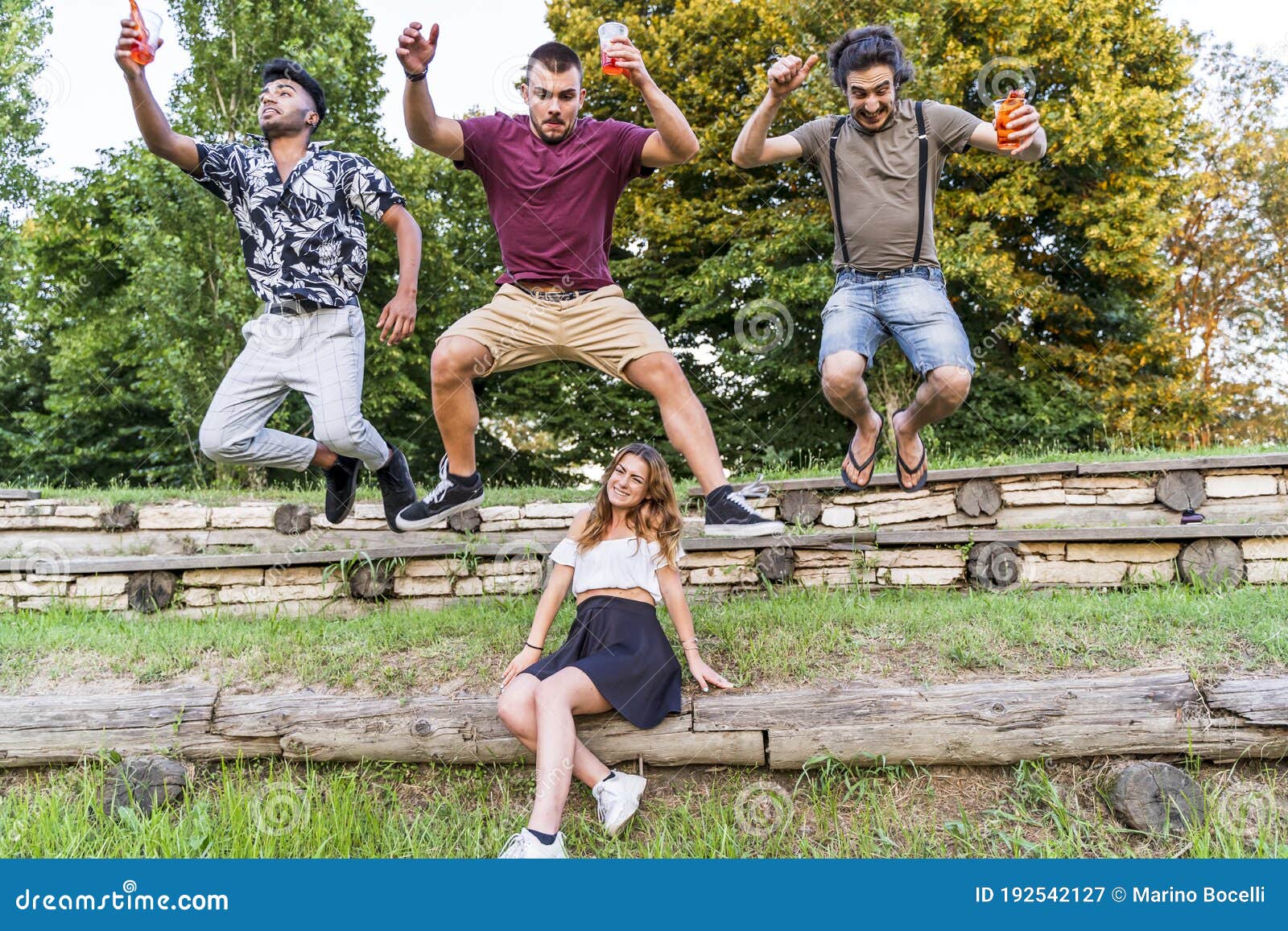 Group of Millennial People Having Fun Jumping while Drinking Colorful ...