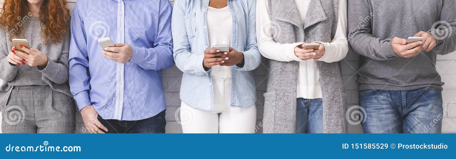 Group of Millennials Using Cellphones, Standing in Row Stock Image ...