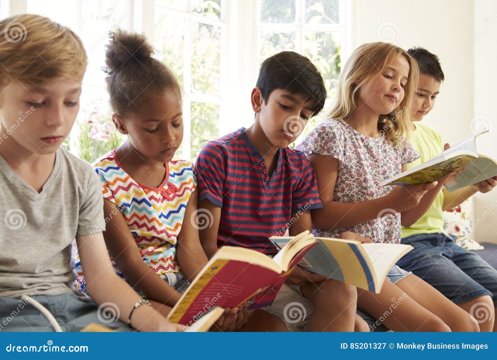 Group of Multi-Cultural Children Reading on Window Seat Stock Image ...