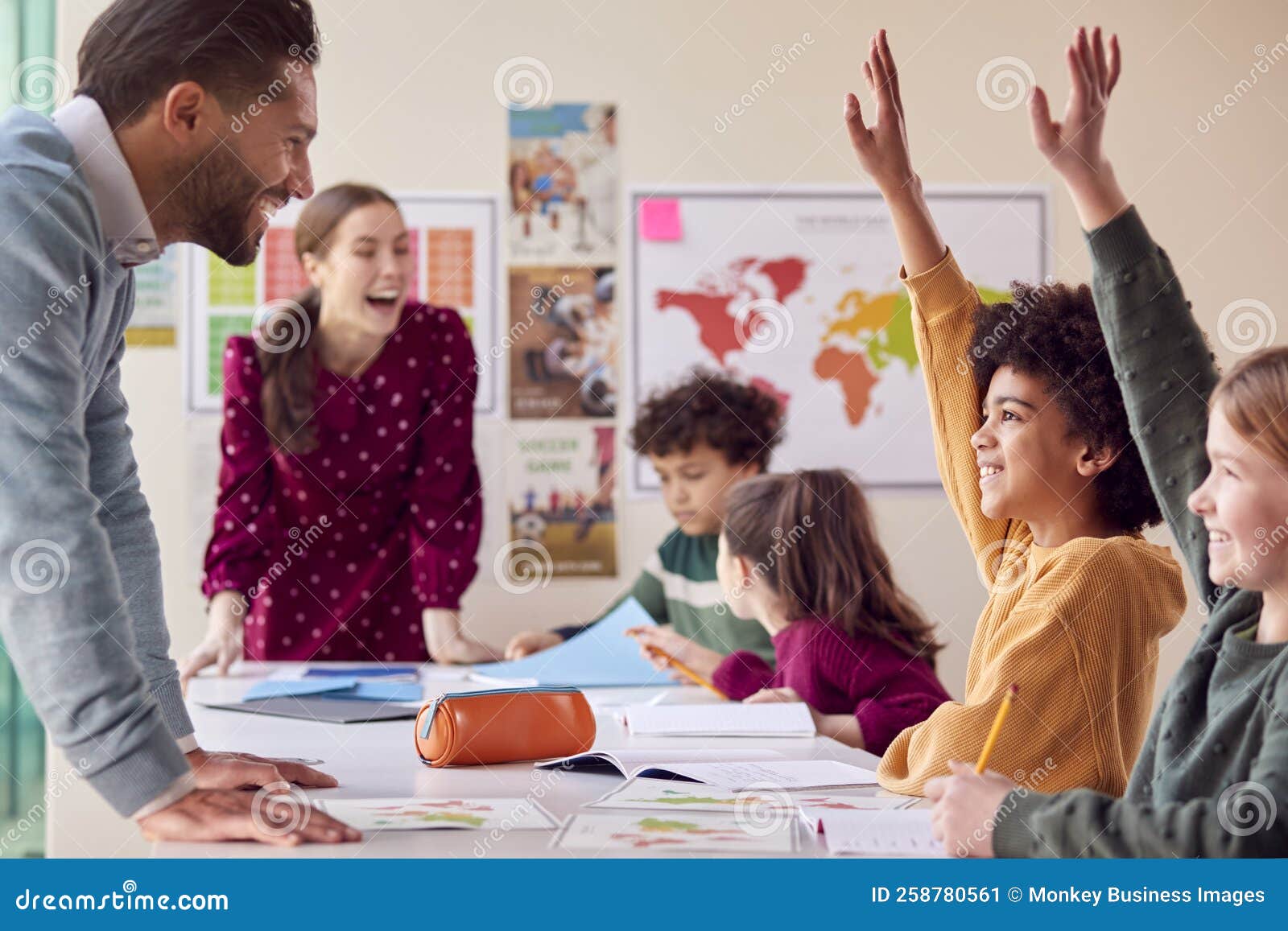 Group of Multi-Cultural Students with Teachers in Classroom Putting ...