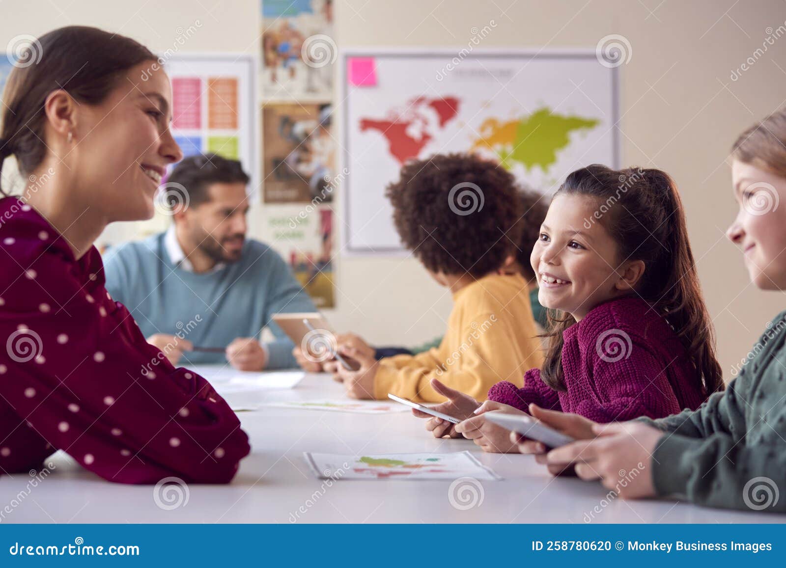 Group of Multi-Cultural Students with Teachers in Classroom Using ...