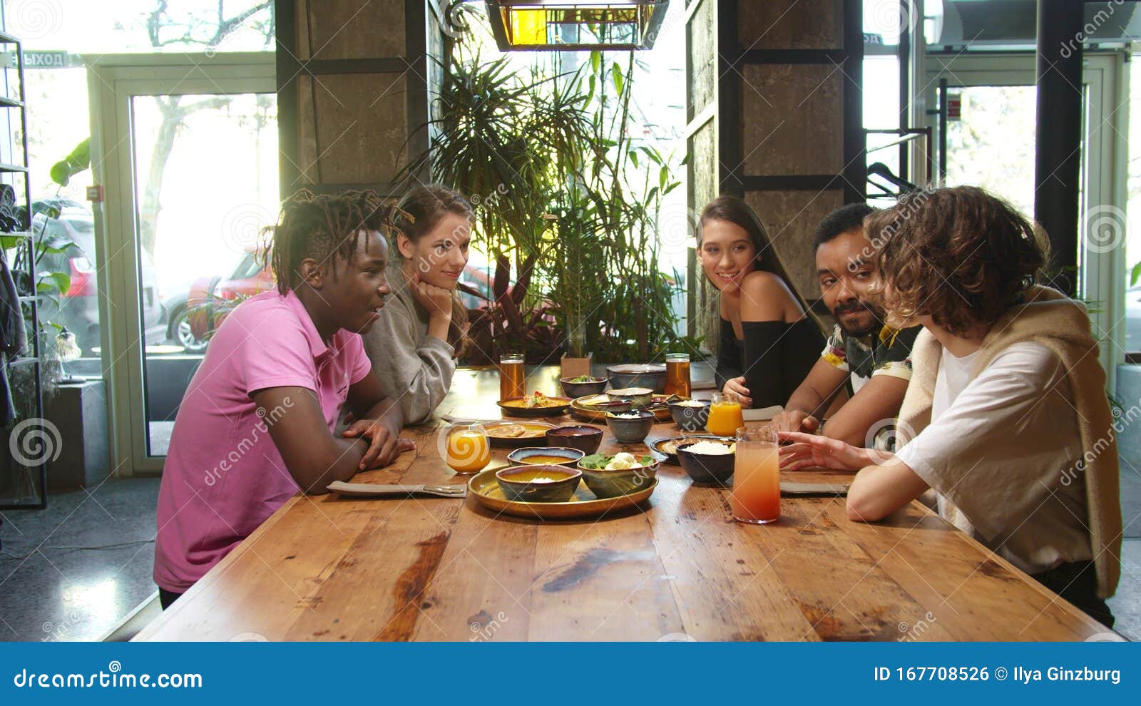 Group of Multicultural Friends Sit at Lunch and Talk Stock Photo ...
