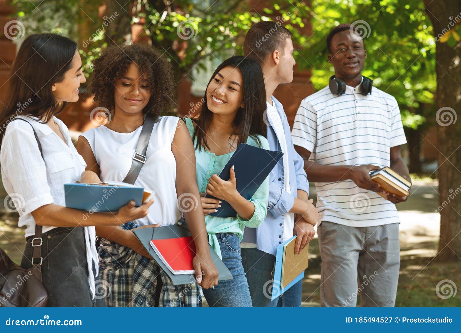 Group of Multicultural Students Resting Outdoors after Classes ...