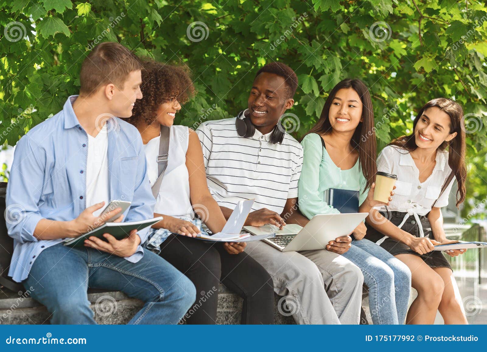 Group of Multicultural Students Sitting in the University Courtyard ...