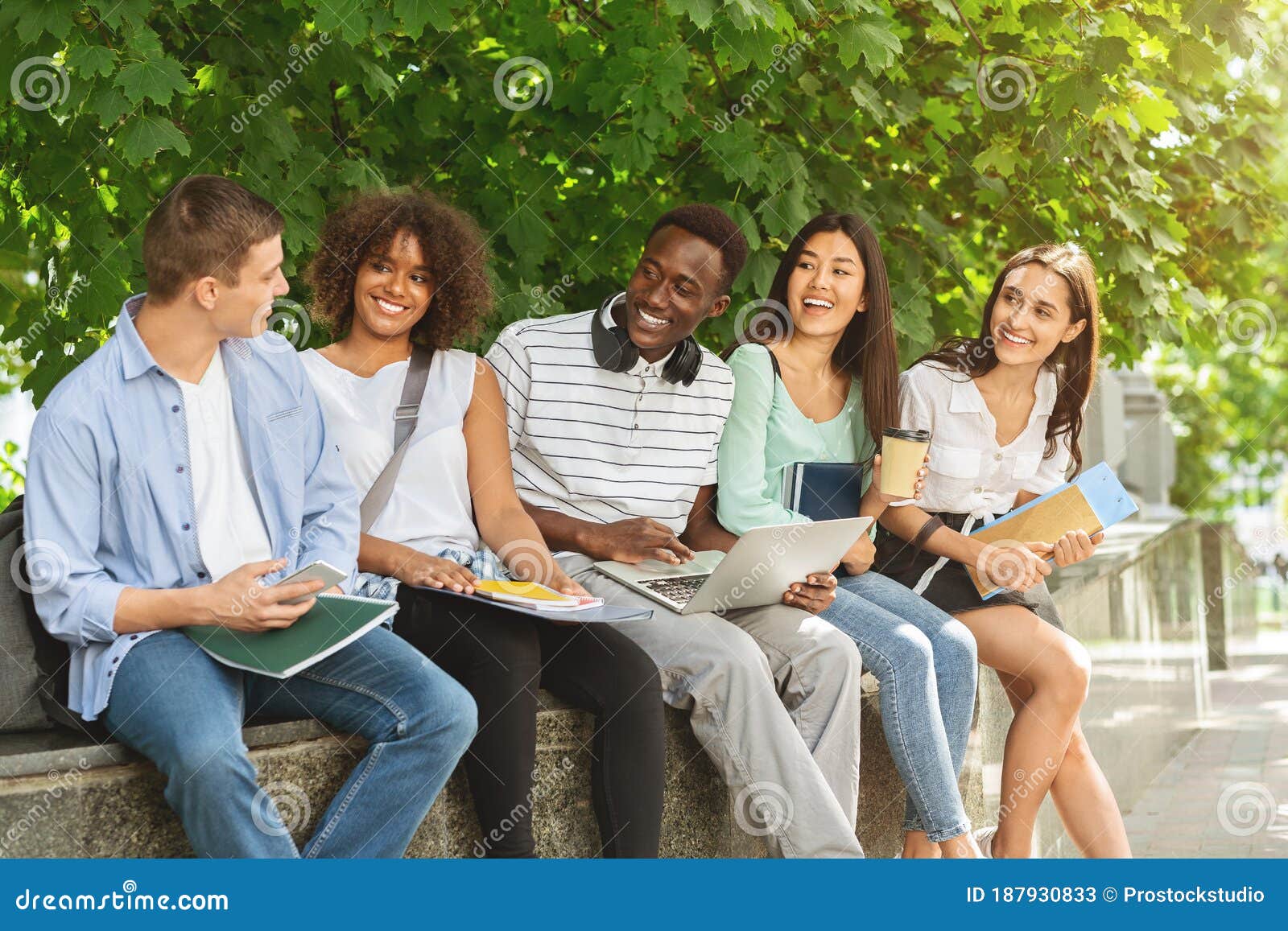 Group of Multicultural Students Sitting in the University Courtyard ...