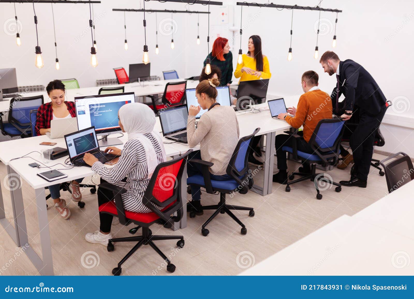 Group of Multiethnic Colleagues Working on Desktop Computers in a ...