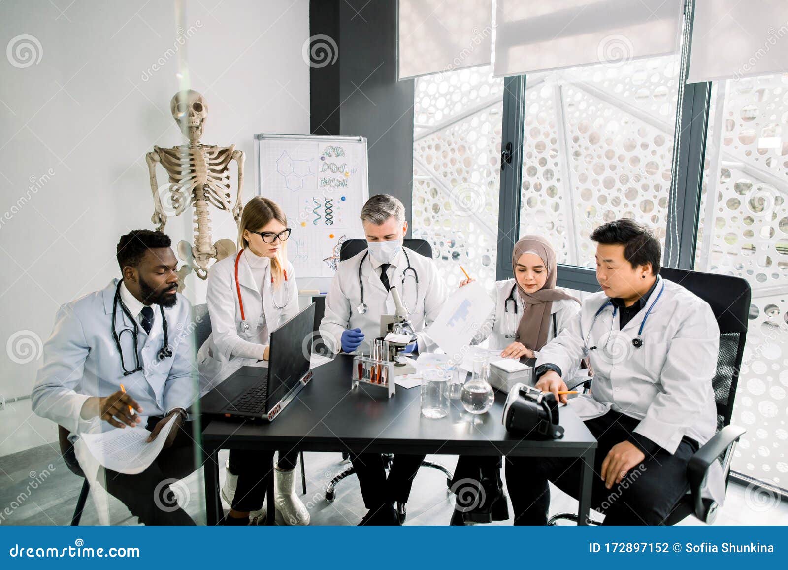 Group of Multiethnic Scientists and Senior Male Supervisor Working with ...