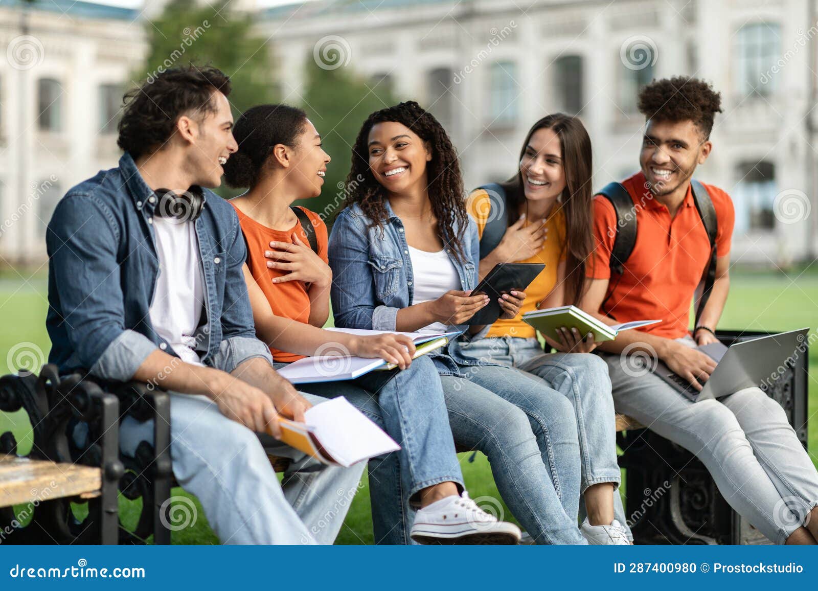Group of Multiethnic Students Chatting and Laughing while Sitting ...