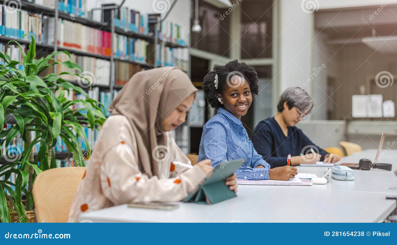 Group of Multiethnic Students in a Library Stock Photo - Image of books ...
