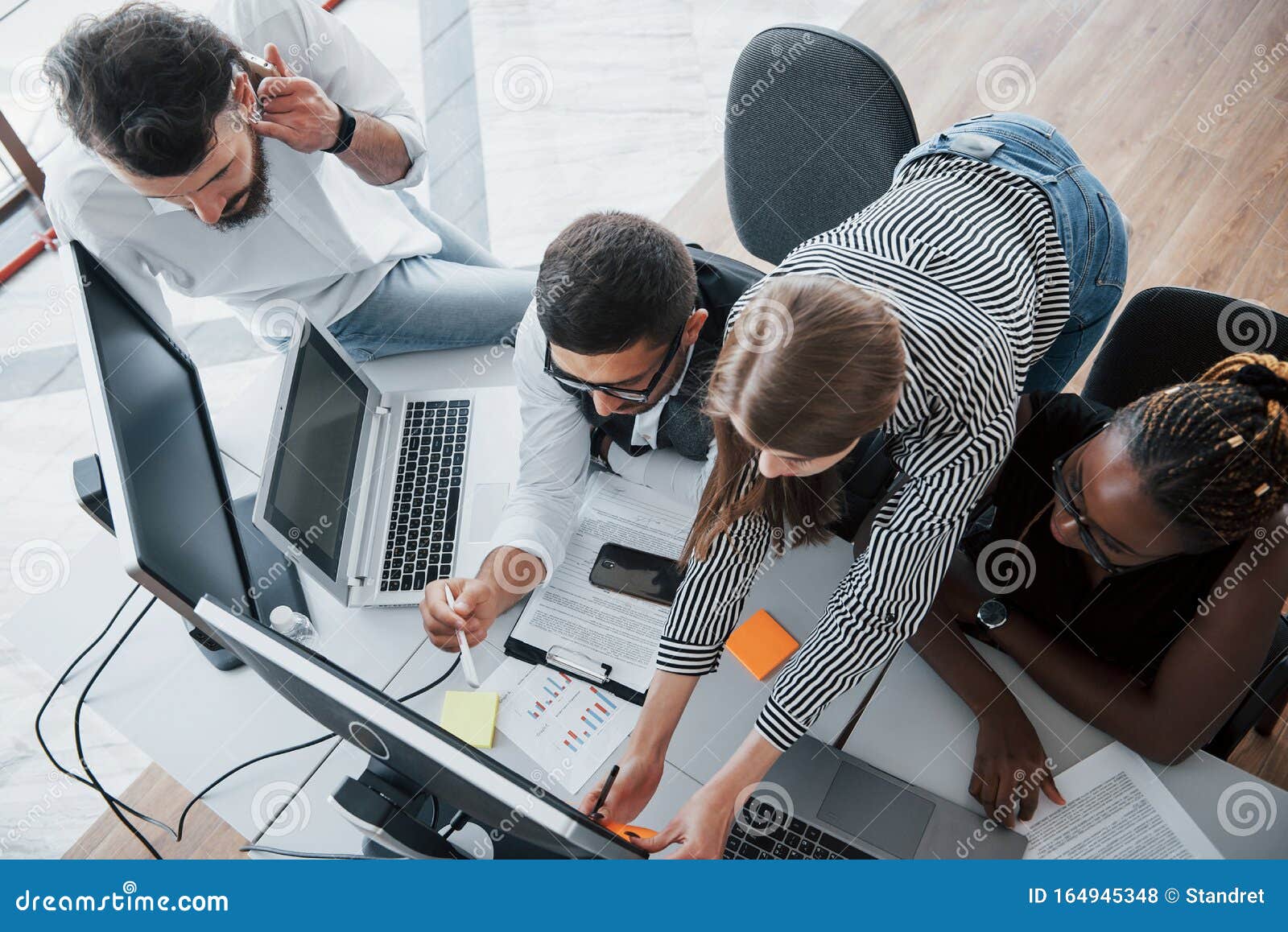 A Group of Multinational Busy People Working in the Office. Stock Photo ...