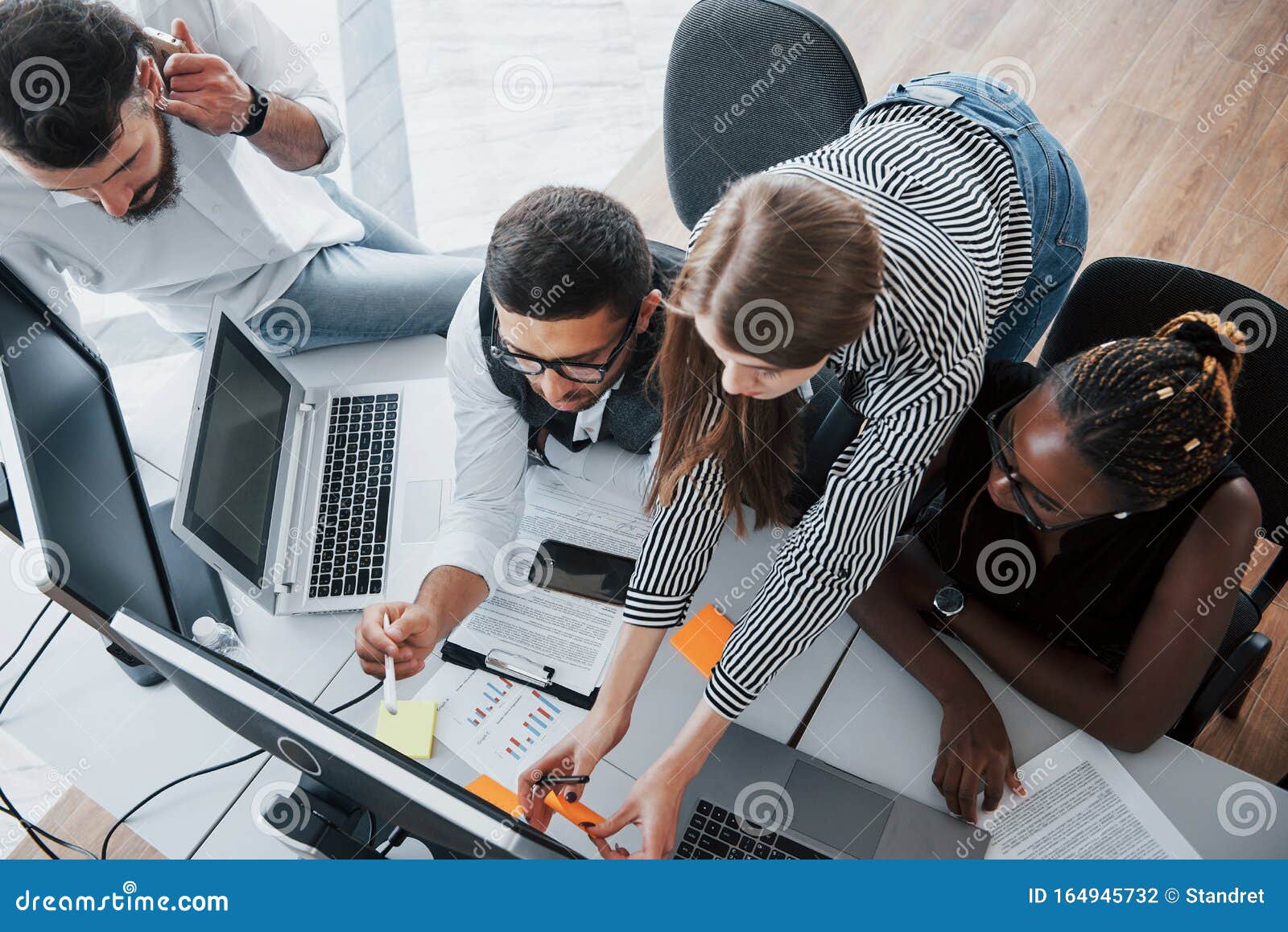 A Group of Multinational Busy People Working in the Office. Stock Photo ...