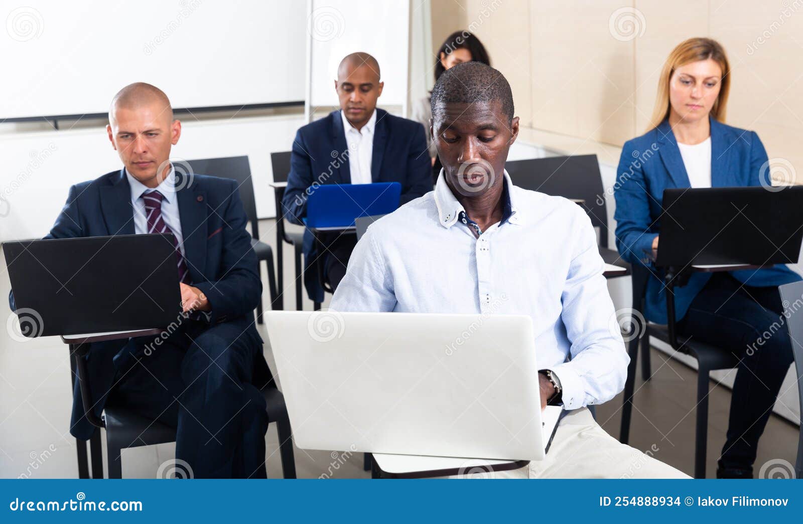 Group of Multinational People Working on Laptops during Business ... Group of Multinational People Working on Laptops during Business ...
