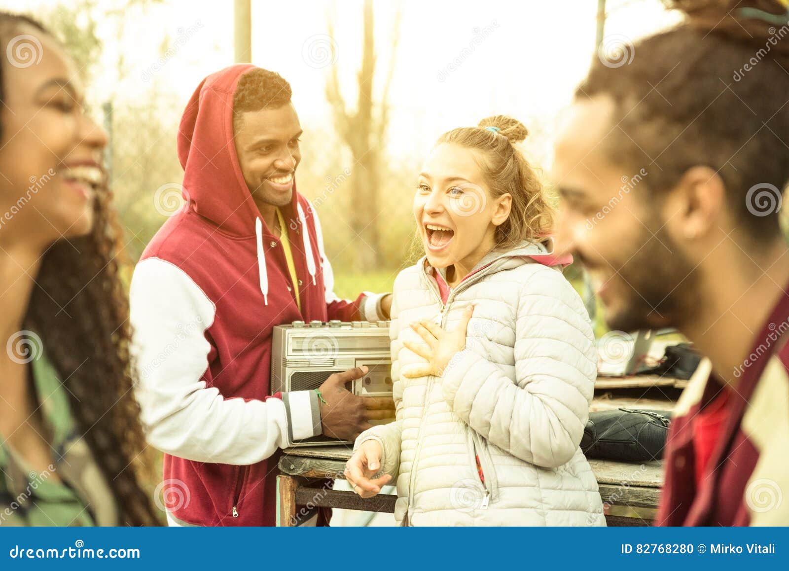 Group Of Multiracial Friend Couples Having Fun Time Out At Park Stock