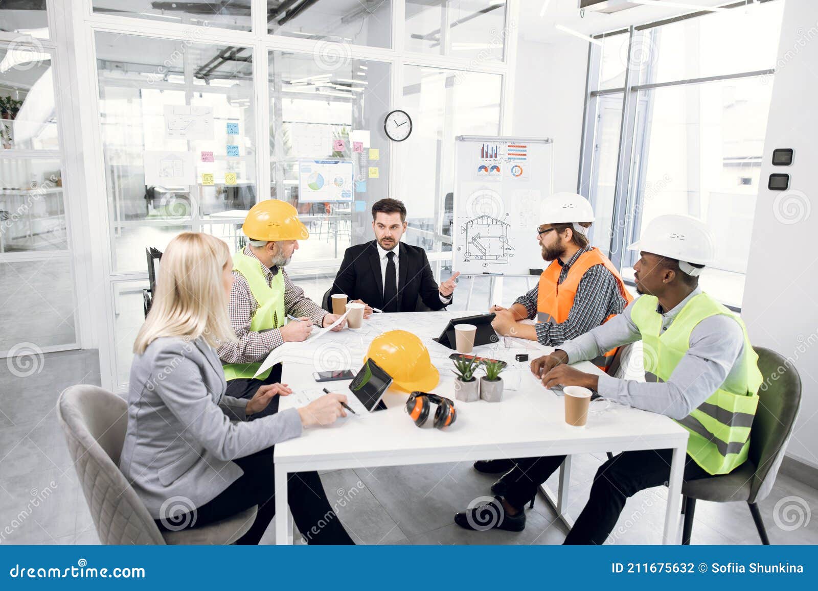 Group of Multiracial People Discussing Construction Project Stock Photo ...