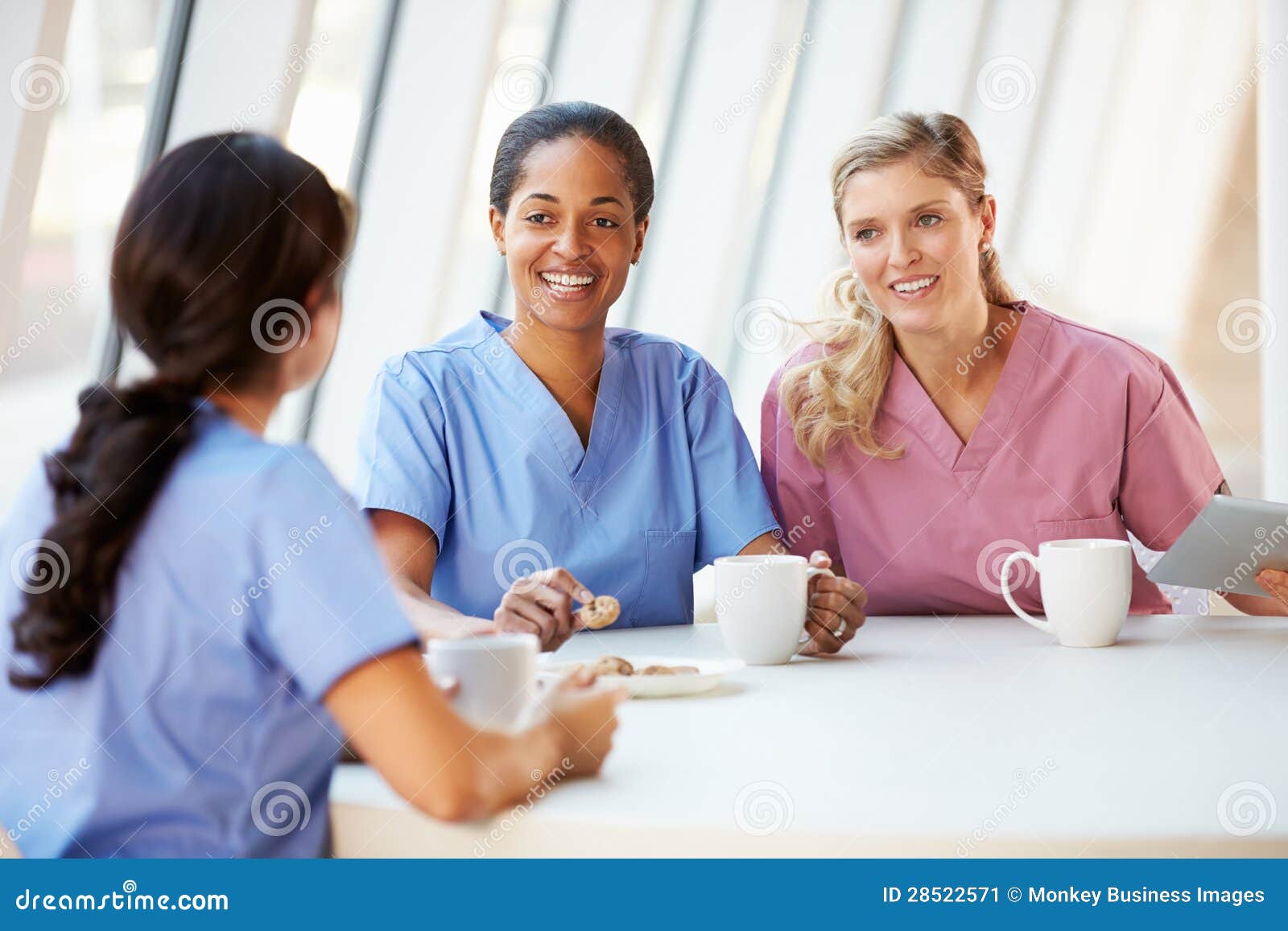 Group Of Nurses Chatting In Modern Hospital Canteen Stock Image - Image ...